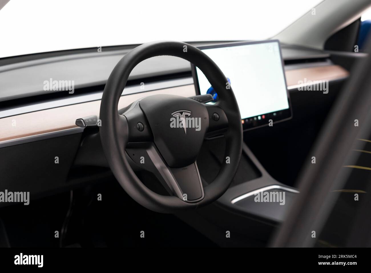 A close-up of an interior Tesla dashboard with a sleek, modern black ...