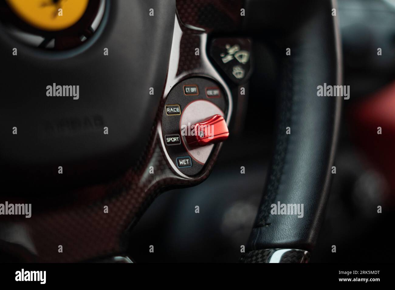 A classic black and white leather Ferrari steering wheel with red ...