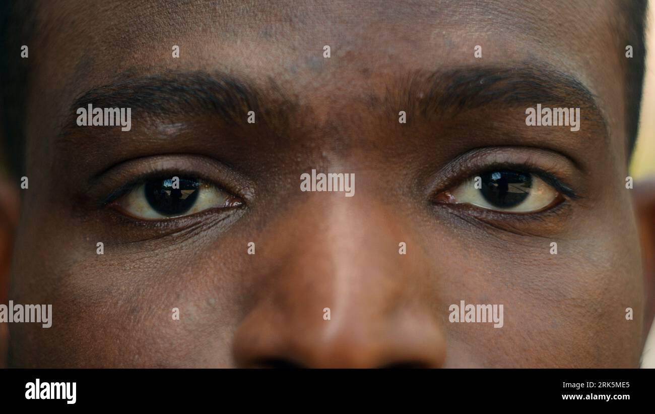 Close up cropped view detail ad male African American ethnic dark eyes ...