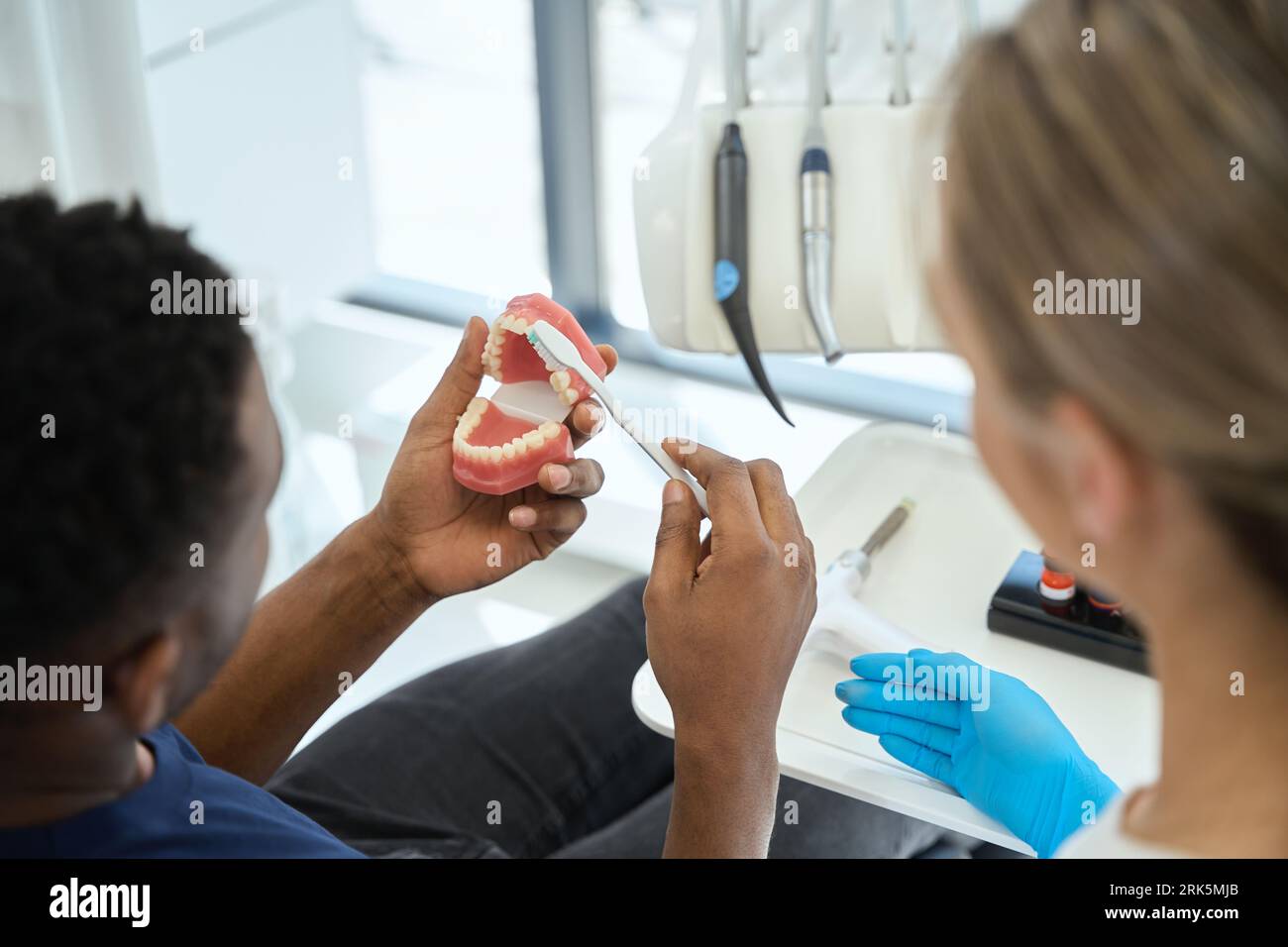 Man brushing model teeth in the dentistry Stock Photo - Alamy