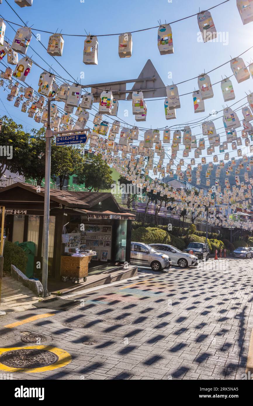 A vibrant and beautiful street scene featuring a sun-drenched arch of ...