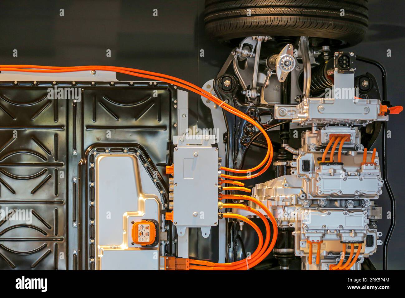 A close-up of a car wheel and electronic device with electrical wiring ...