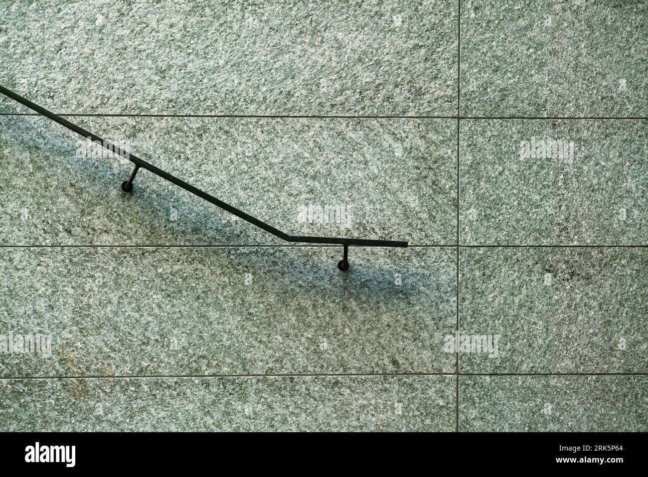 handrail, construction detail of a building, with a wall with granite ...