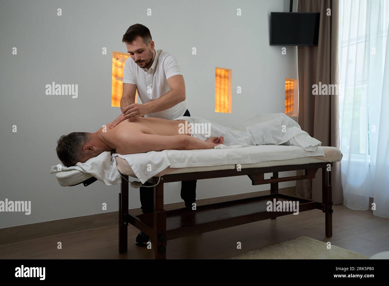 Massotherapist performing myofascial release therapy session on patient ...