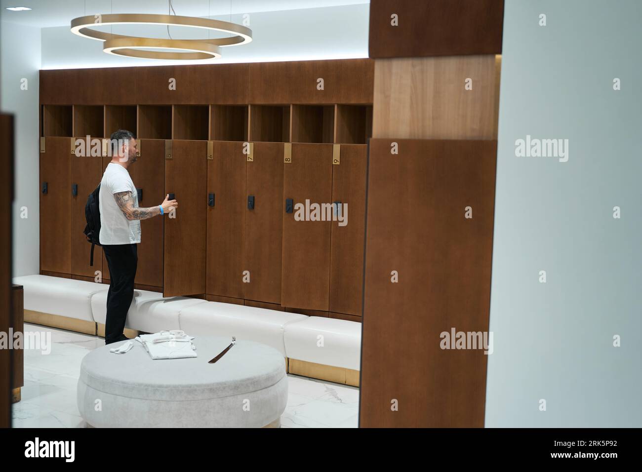 Wellness center client standing in luxurious changing room Stock Photo ...