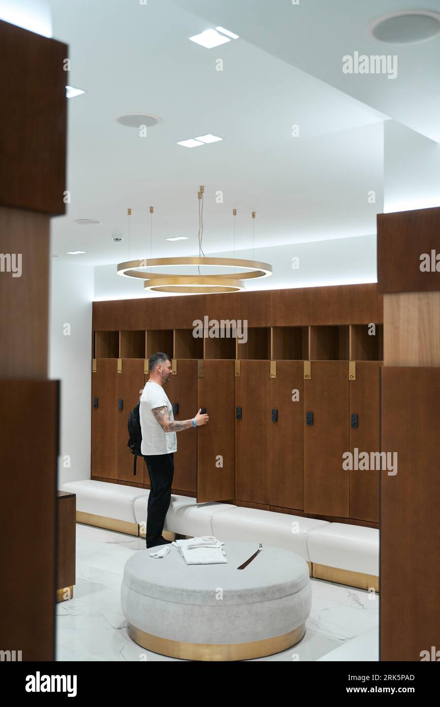 Wellness center client preparing to change his clothes Stock Photo - Alamy