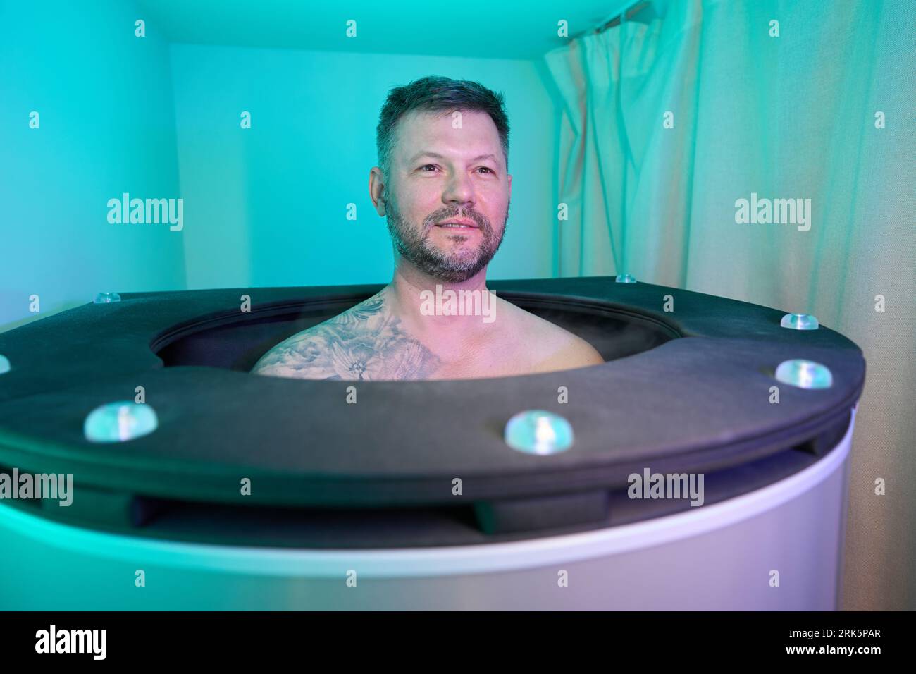 Spa client is undergoing whole body cryotherapy session Stock Photo - Alamy