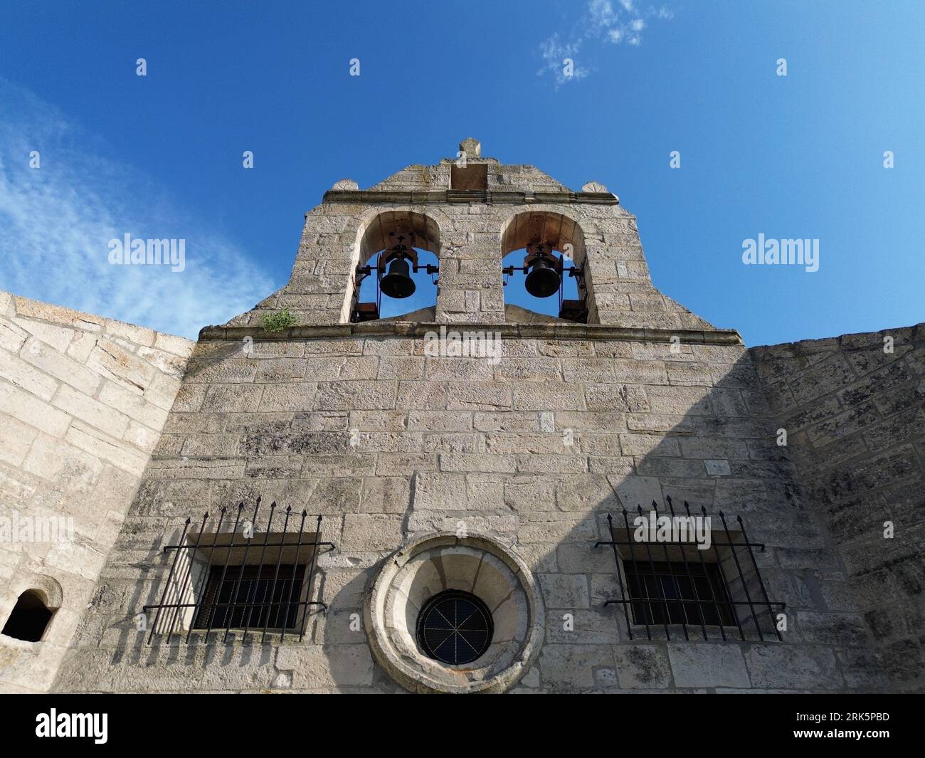 An ornate bell tower featuring four bells connected together by metal ...