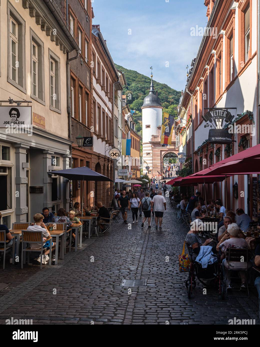 A picturesque cobblestone street with cafes in Heidelberg. Germany ...