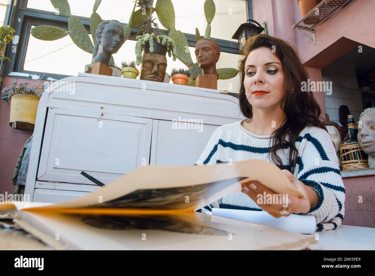 French Caucasian adult woman drawing student concentrated at home ...