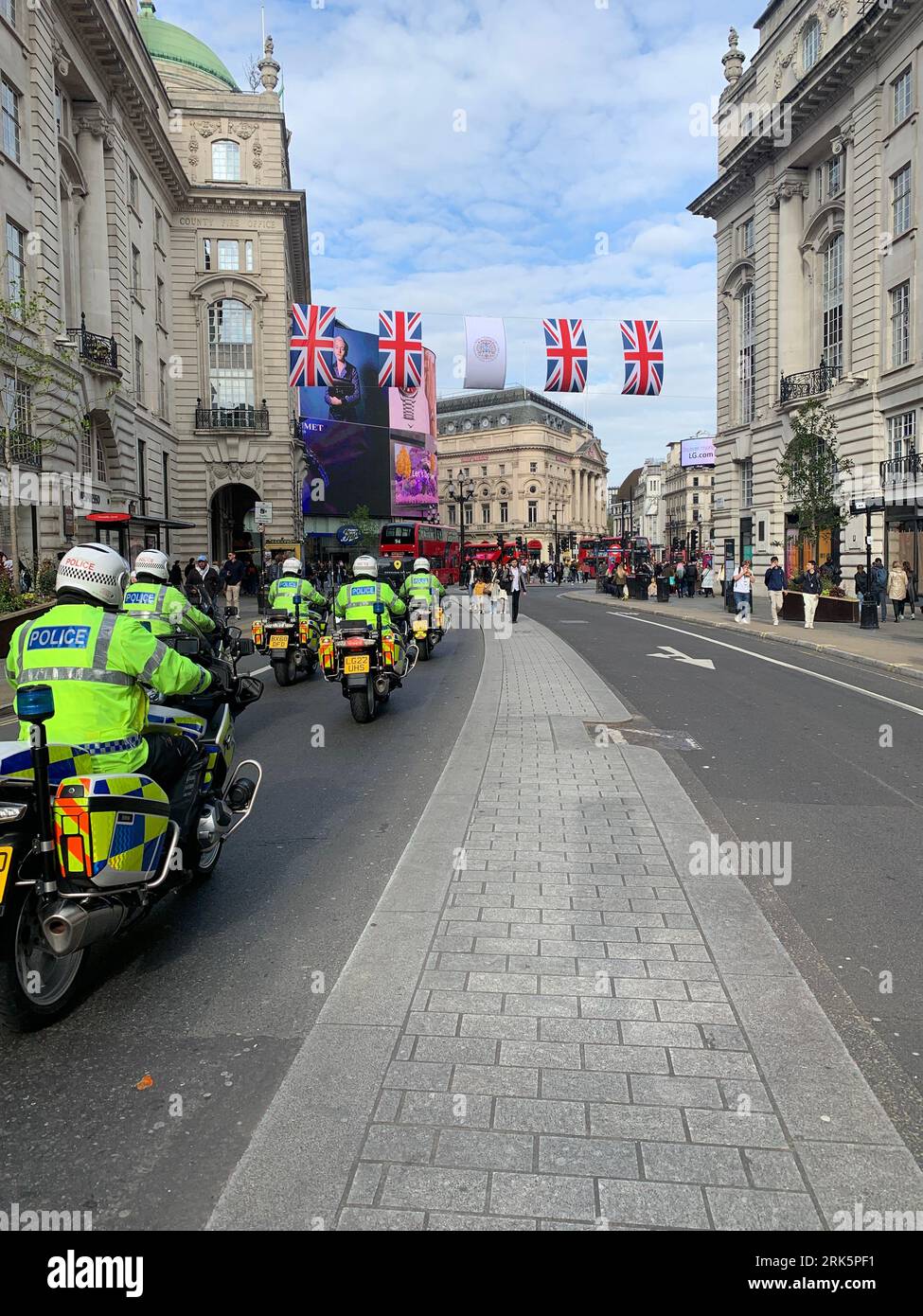 Officers of the London Metropolitan Police Force ride motorcycles in ...