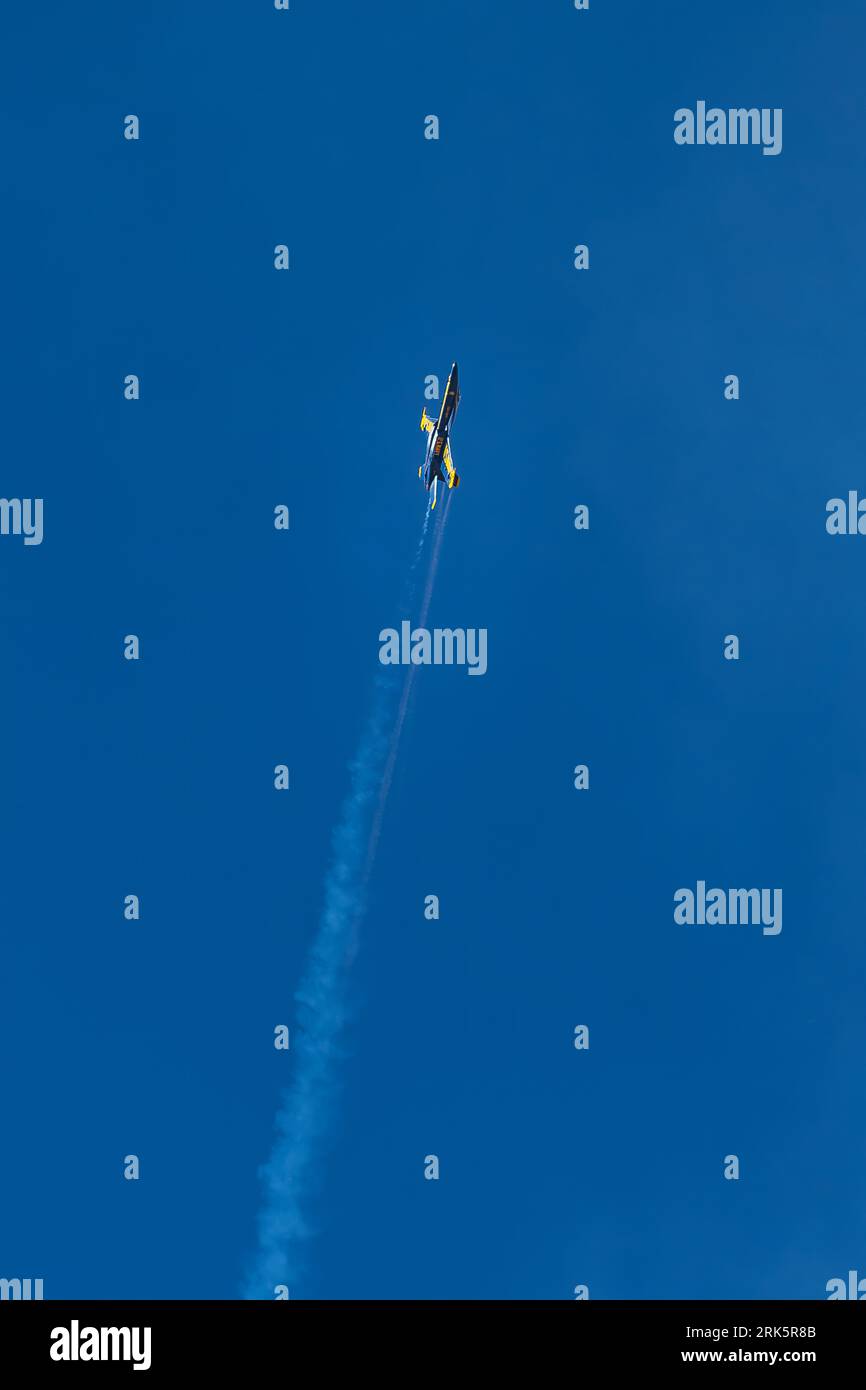 A U.S. navy blue angels jet flies through the sky, performing an ...