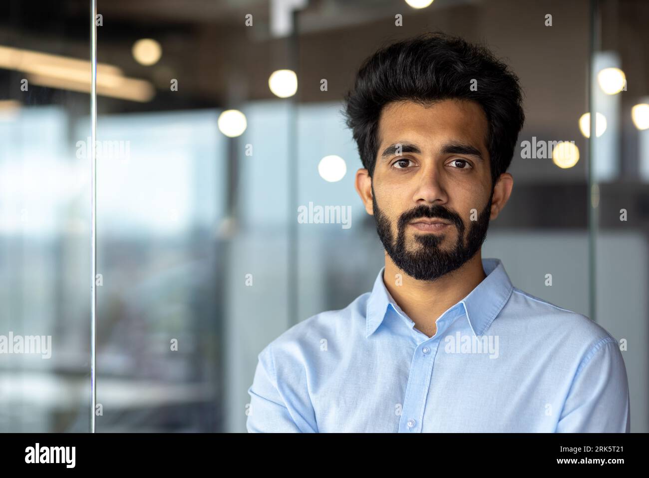 Close-up photo. Portrait of a young Indian businessman man wearing a ...