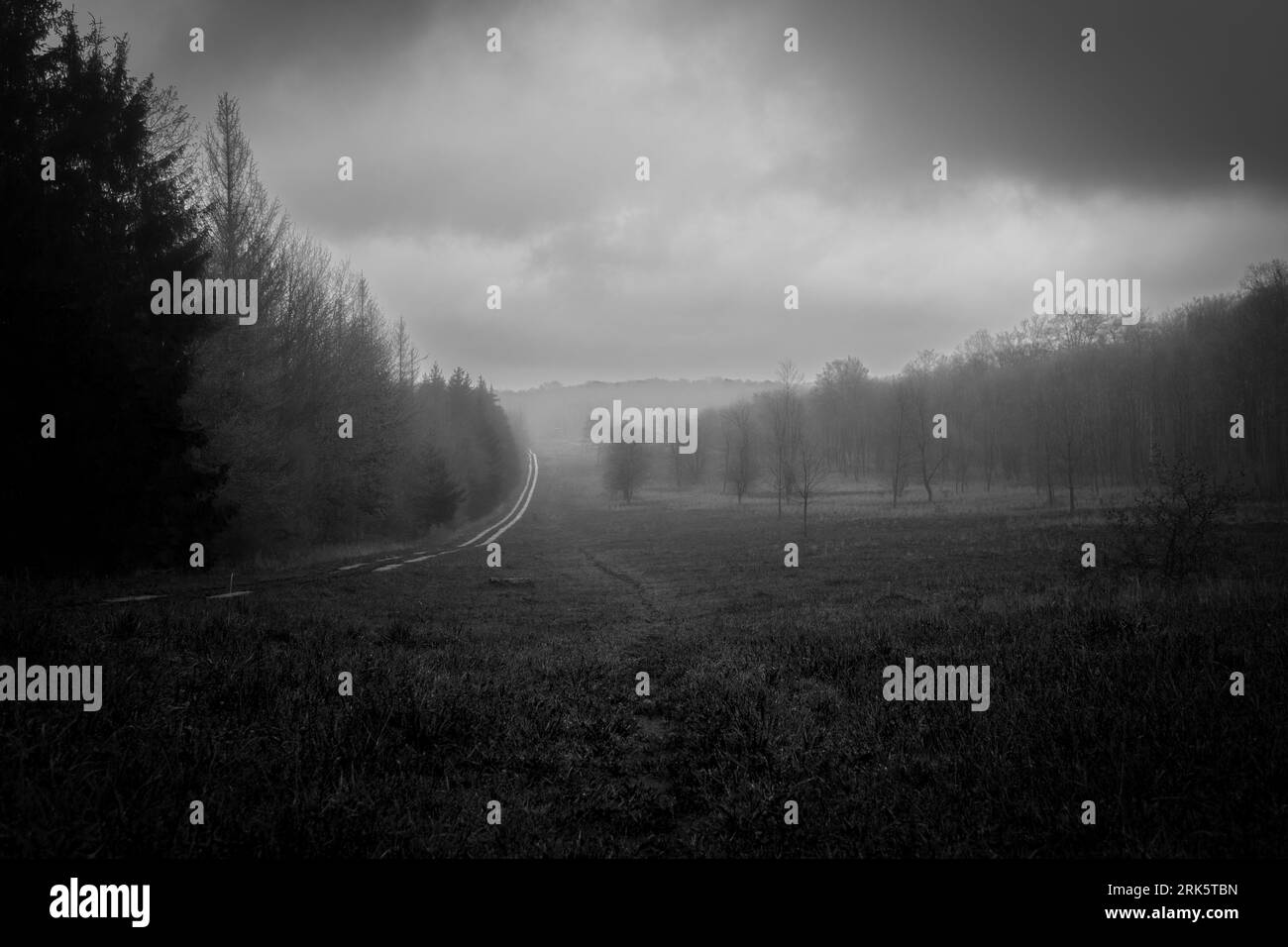 A scenic view of a countryside landscape shrouded in haze, with an ...