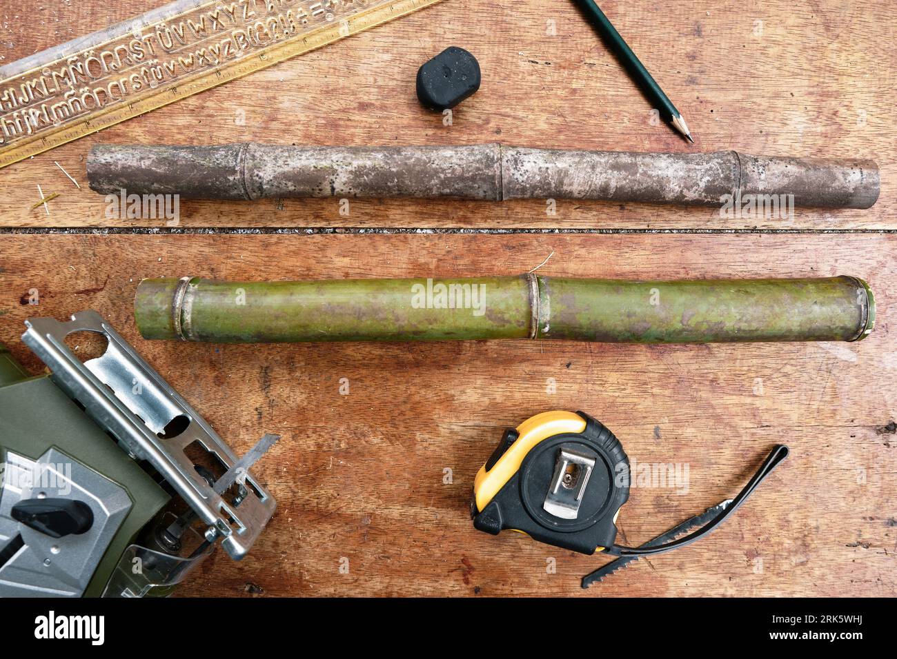 top view bamboo rods cut from wood on a table with tools around them ...