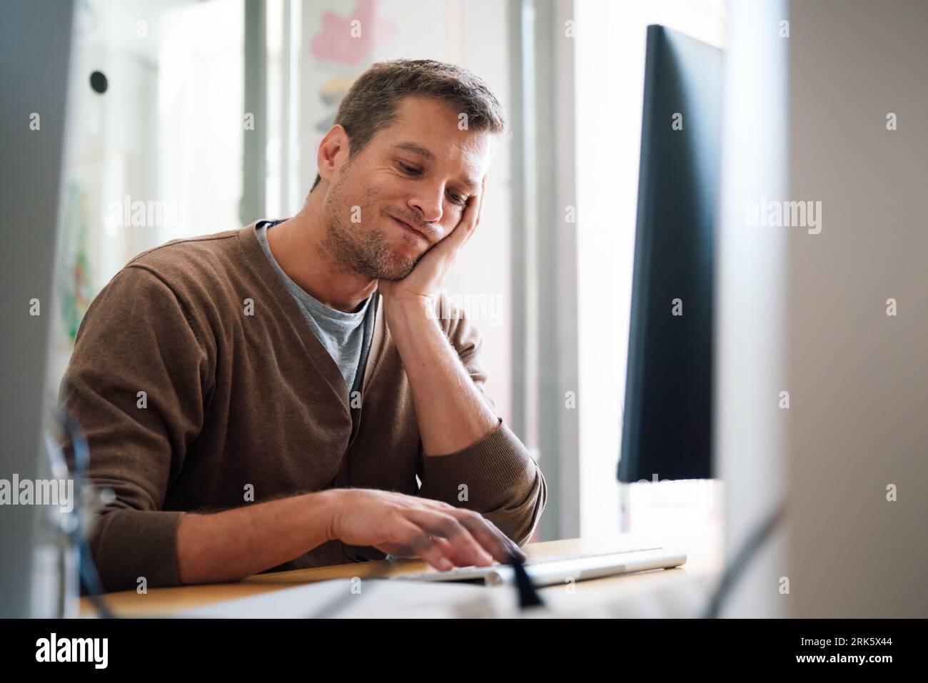 Overworked tired employee, programmer at workplace in office being ...
