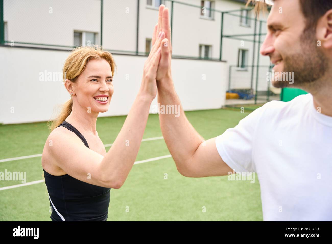 Tennis partners greet each other on the tennis court Stock Photo - Alamy