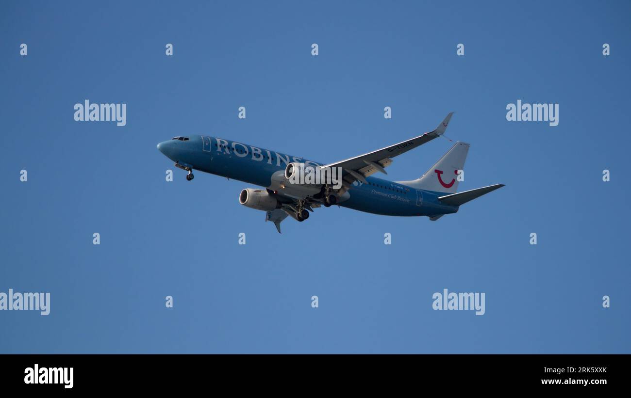 A modern, commercial airplane flying in the sky, viewed from below ...