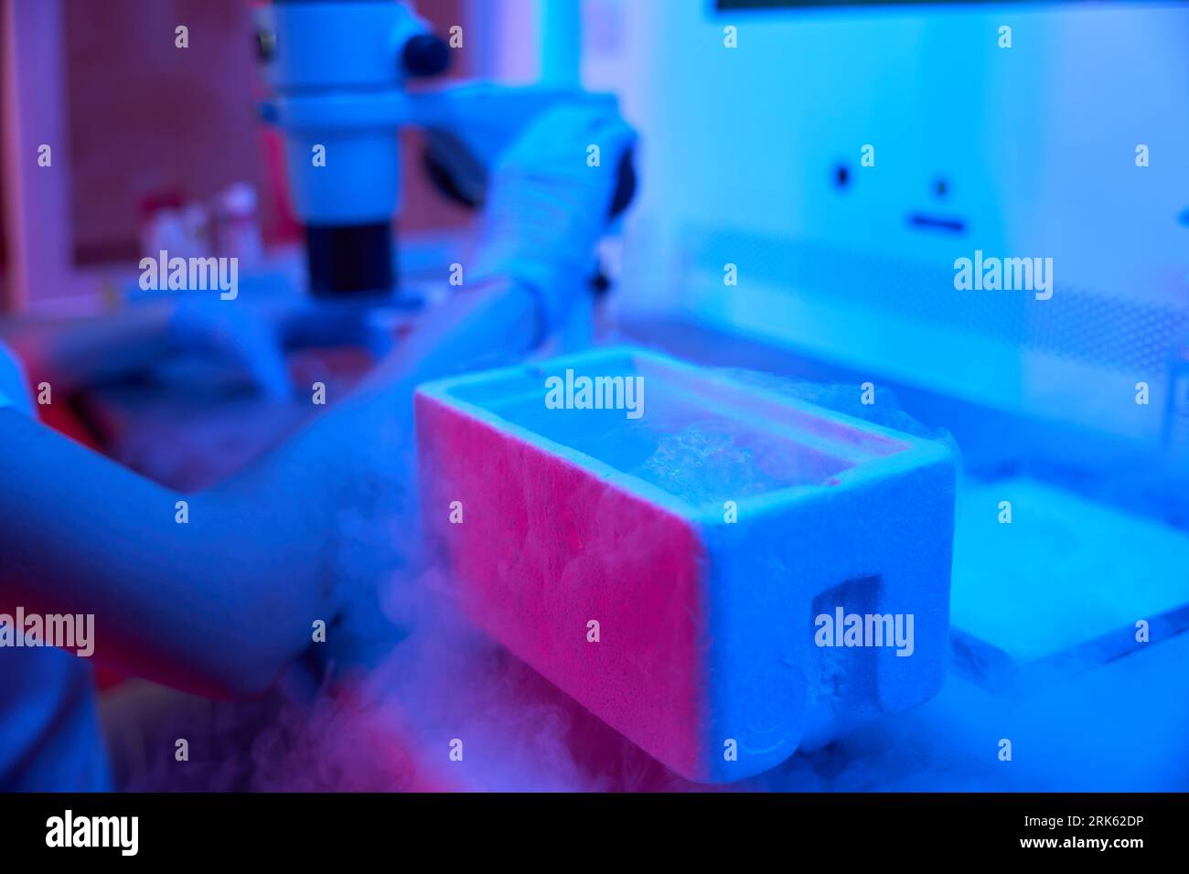 Laboratory worker at workplace uses a powerful microscope Stock Photo ...