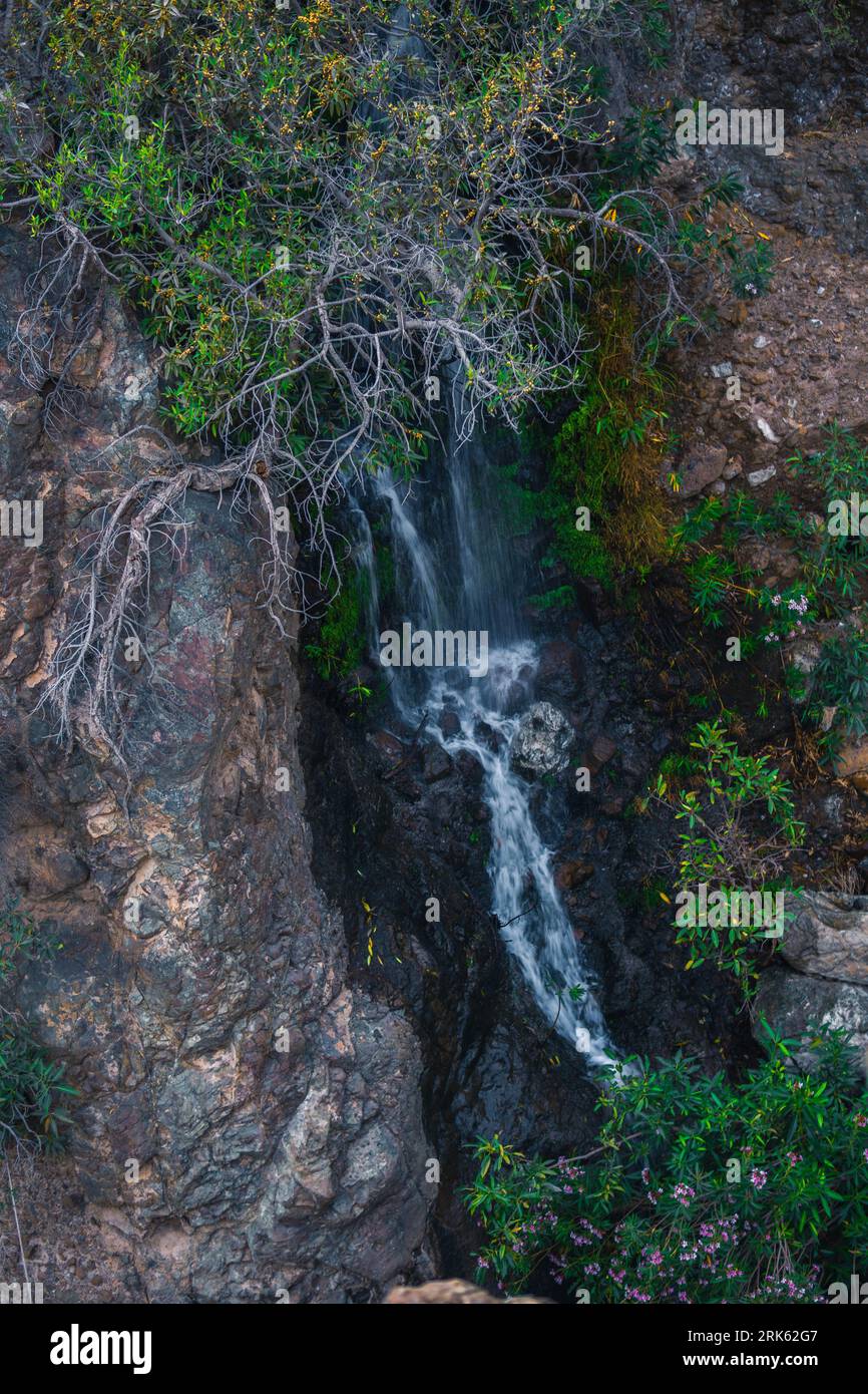 A breathtaking view of a waterfall cascading between two majestic ...