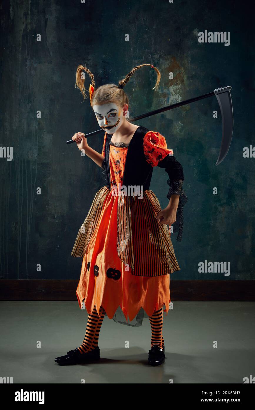Making fear. Child, little girl with creepy full face makeup and ...