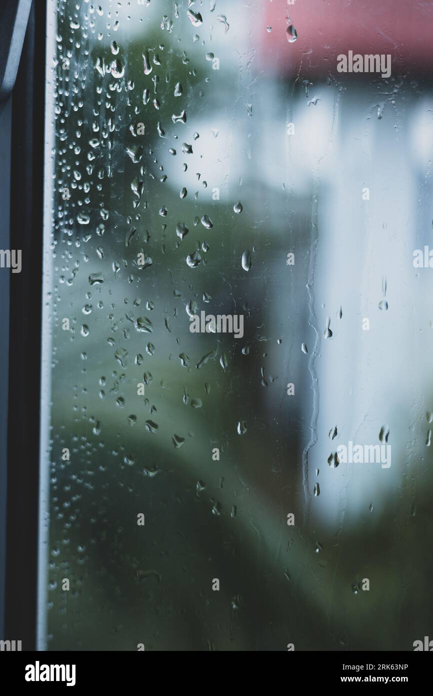A close-up image of a window pane with water droplets running down the glass Stock Photo - Alamy