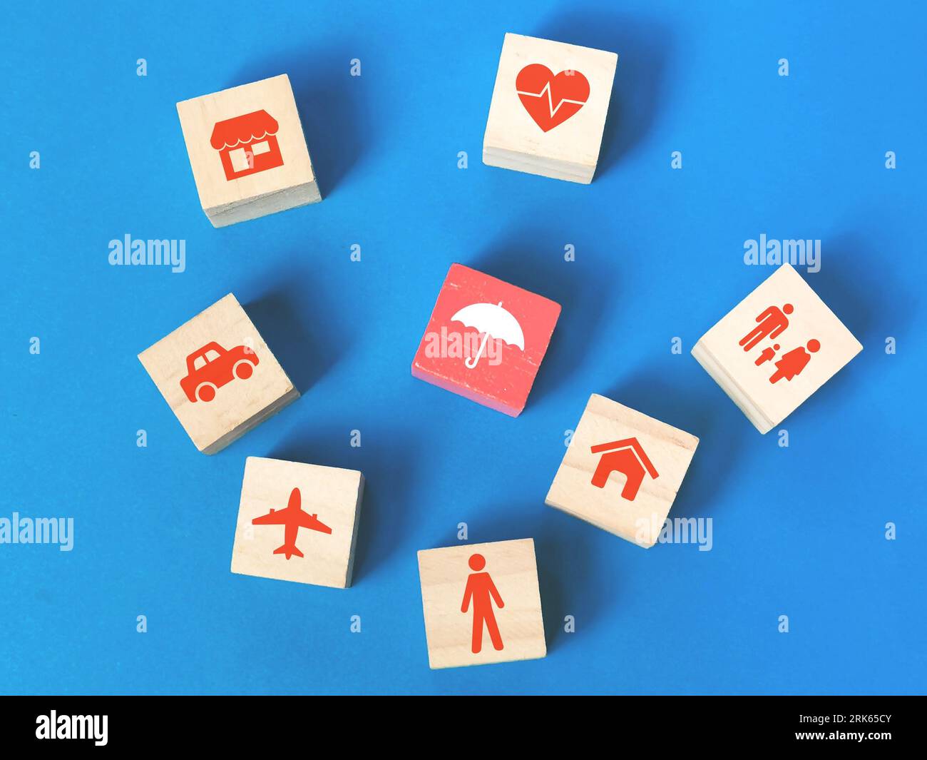 A top view of wooden blocks with various symbols for insurance coverage ...