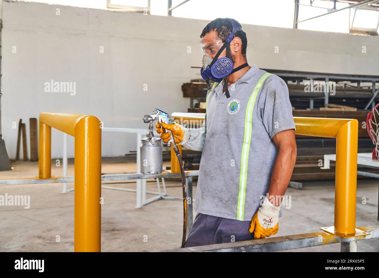 working man in a workshop/factory. man working on metal. metalworking ...