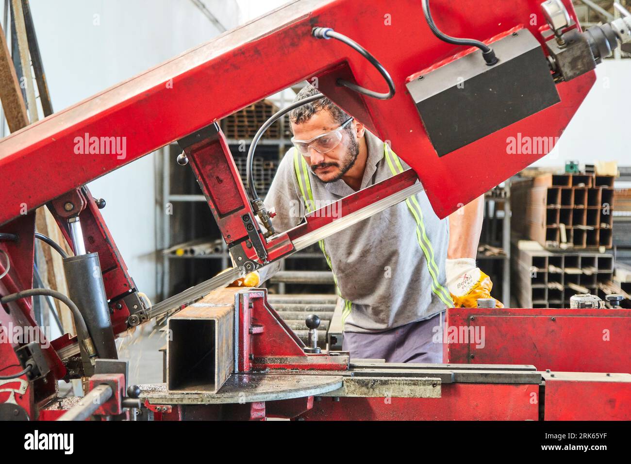 working man in a workshop/factory. man working on metal. metalworking ...