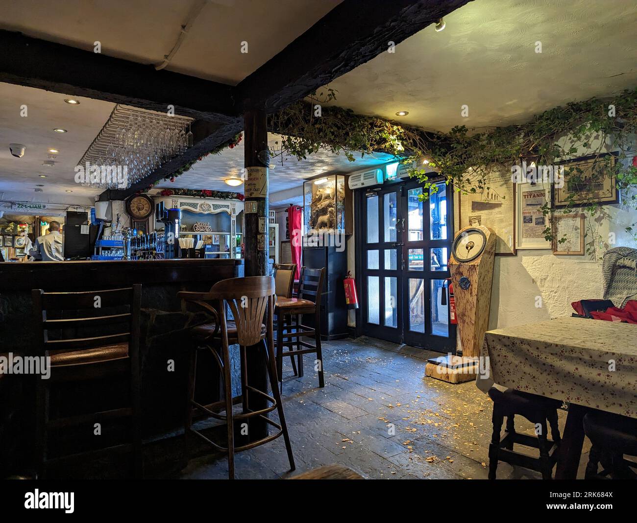 A stylish, yet rustic bar is seen in this image, featuring a wooden bar ...