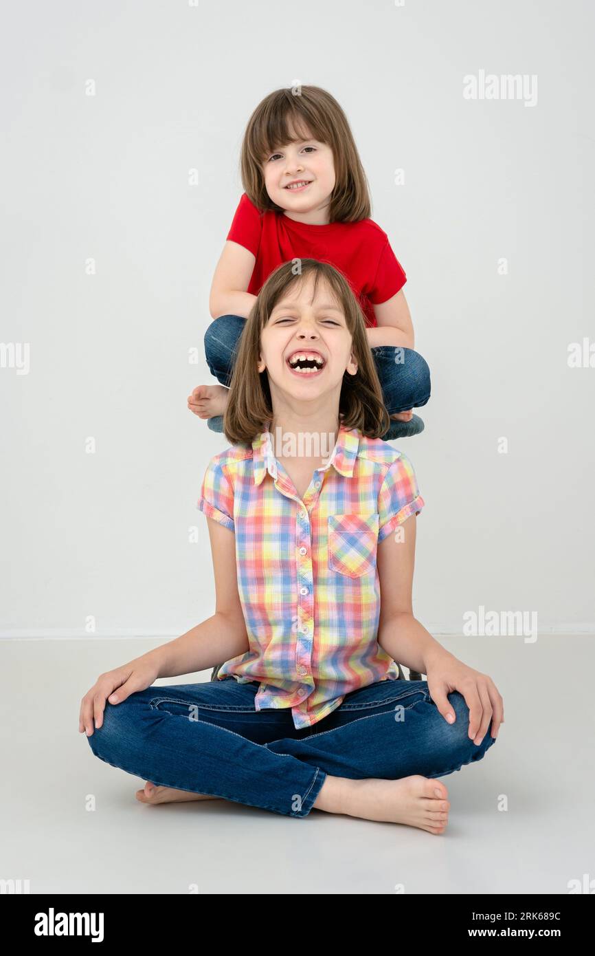 Portrait of two happy girls in studio against white background Stock ...
