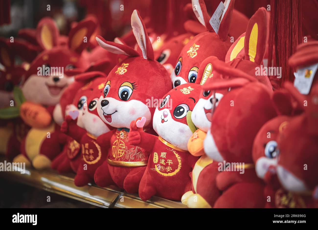 Two plush teddy bears dressed in vibrant Chinese red costumes are ...