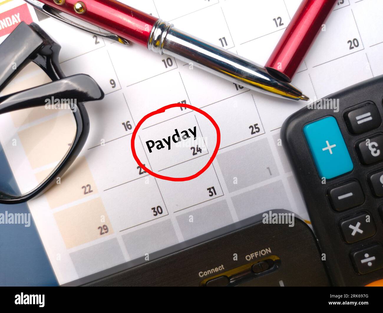 A calendar displaying the word payday in bold red lettering, surrounded ...