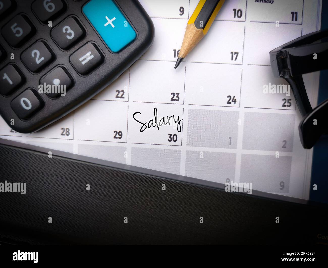 An image of a calendar with a calculator, pencil and pencil holder on ...