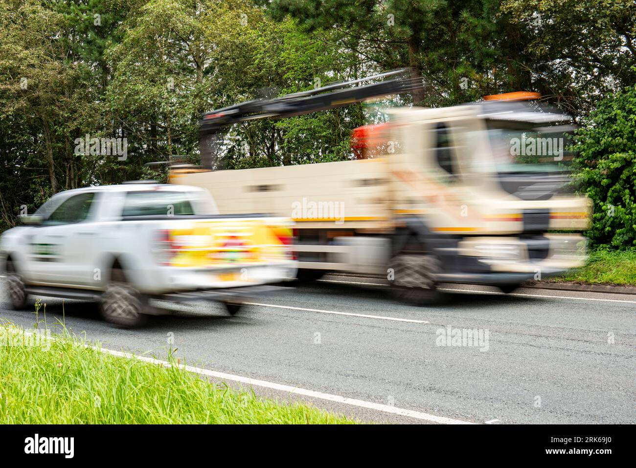Speeding lorry and pick up van on motorway UK Stock Photo - Alamy
