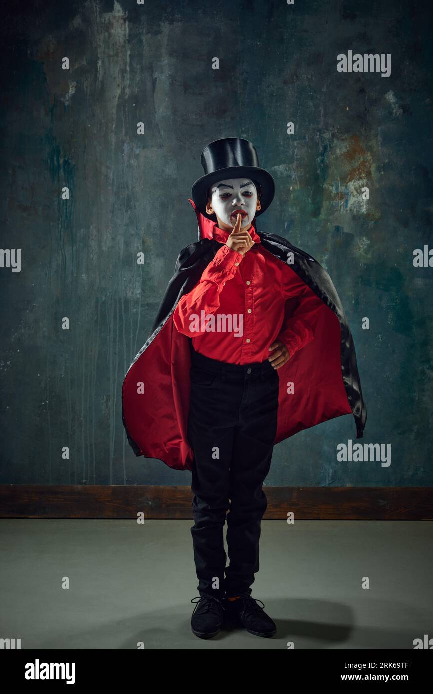 Shh. Keeping secret. LLittle boy, child in image of creepy vampire ...