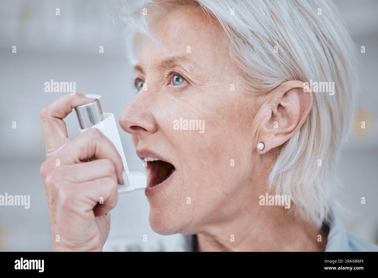 Senior woman, asthma inhaler and breathe with pharmaceutical product ...