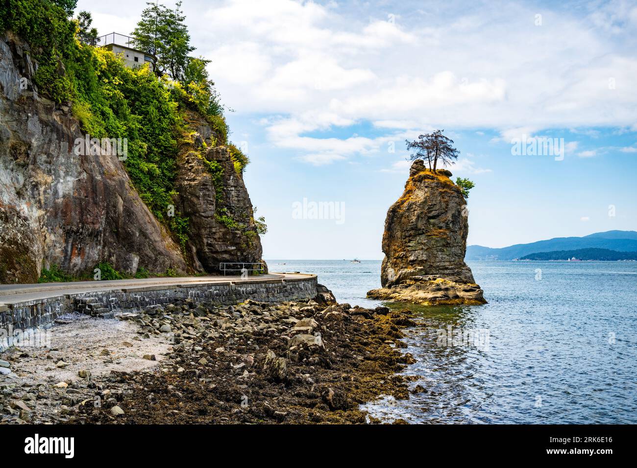 Siwash Rock is a landmark outcropping near the seawall at the west side ...