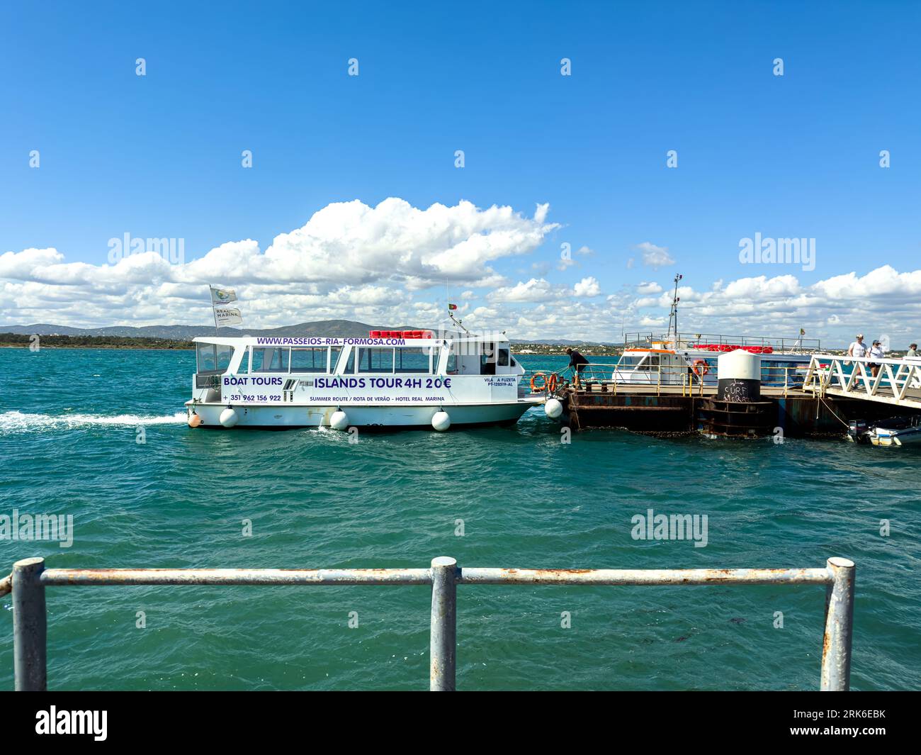 A Ria Formosa Tour boat ferrying tourists from Olhao mainland to the ...