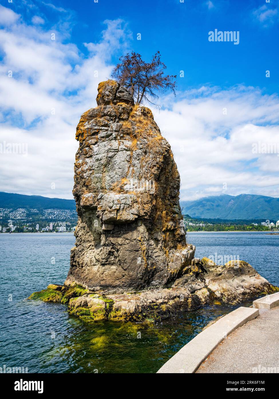 Siwash Rock is a landmark outcropping near the seawall at the west side ...