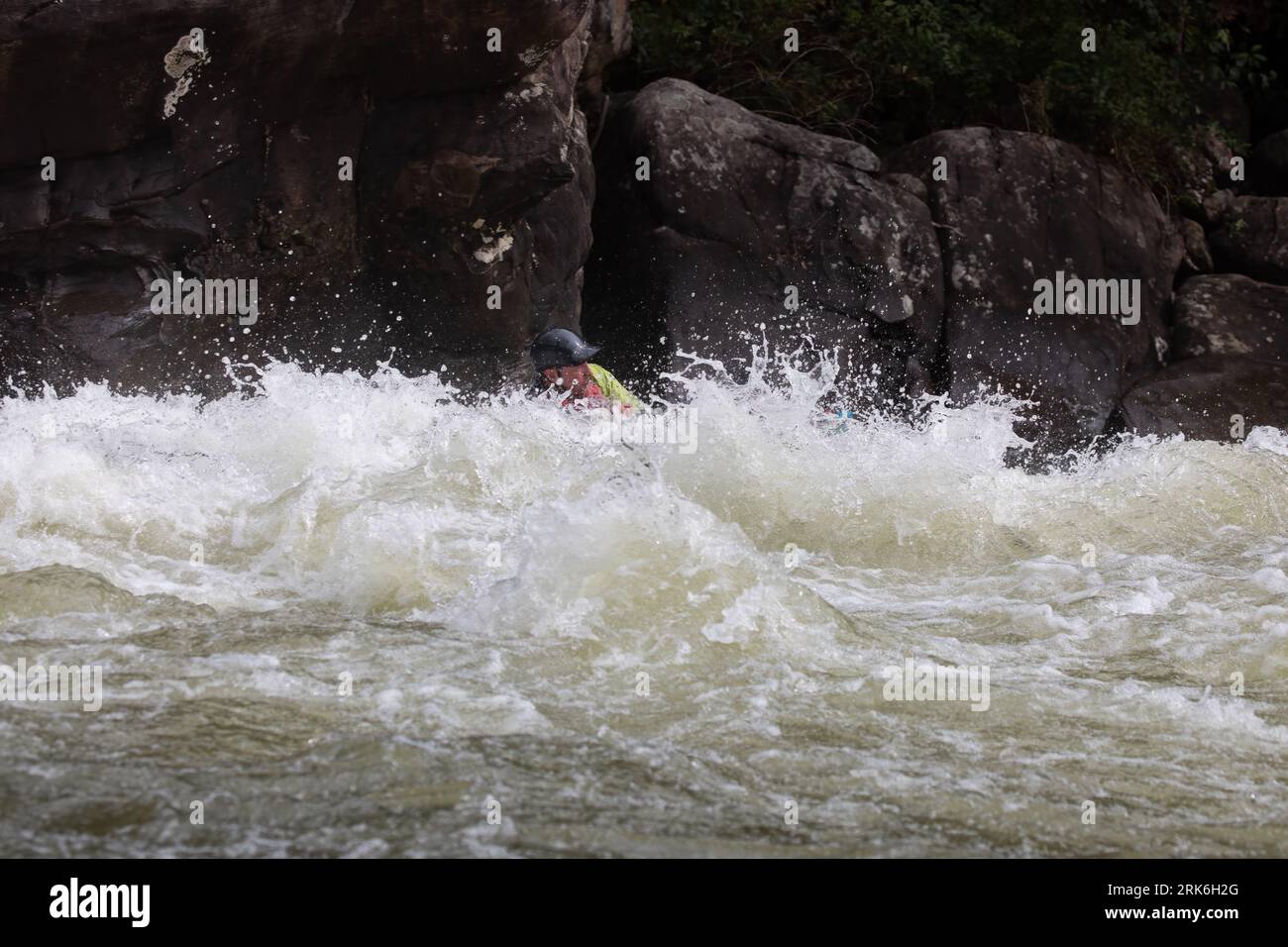 A group of people in a kayak navigating through the choppy waters of a ...