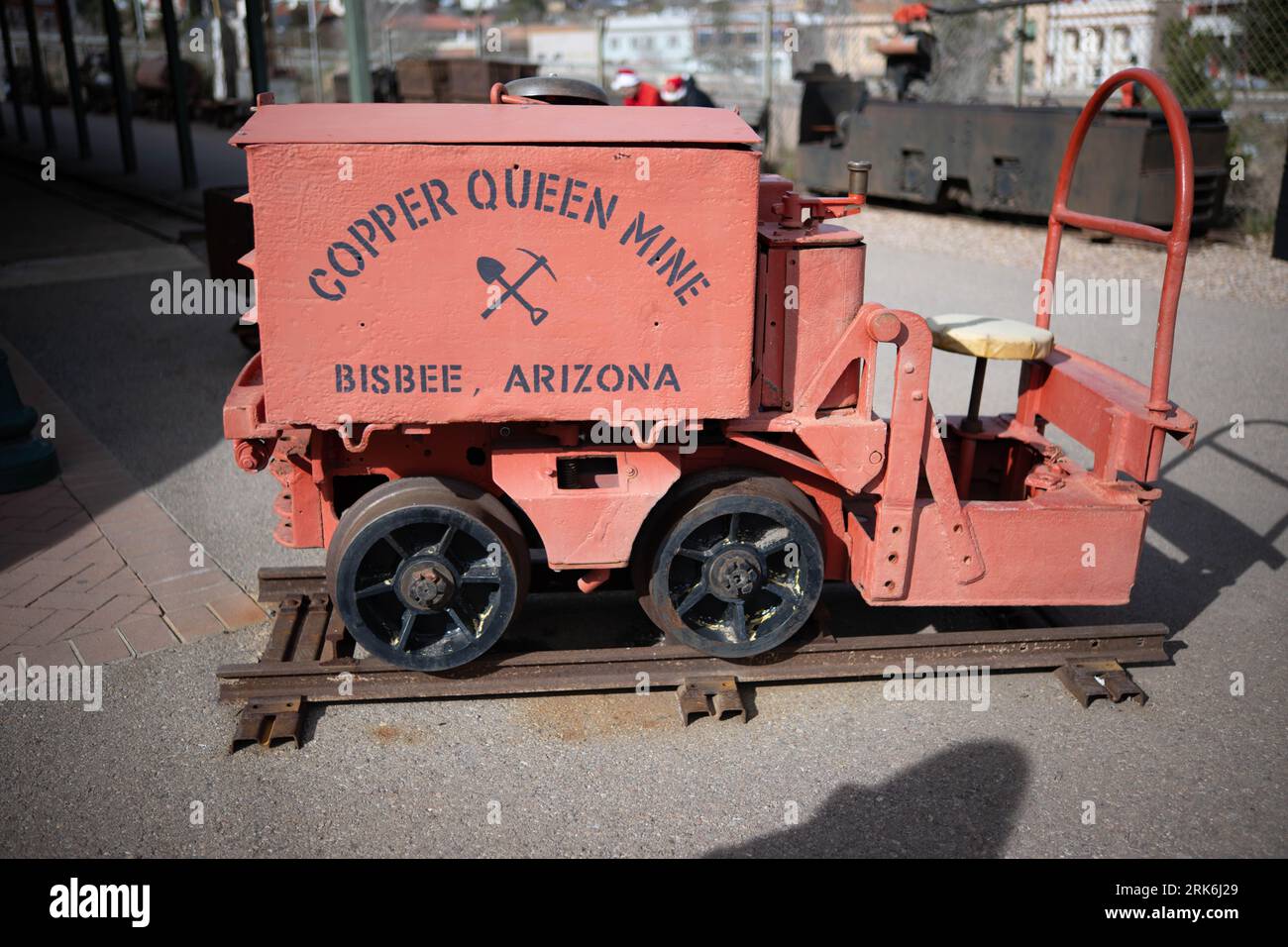 A close-up view of a miniature railroad car on a set of tracks ...