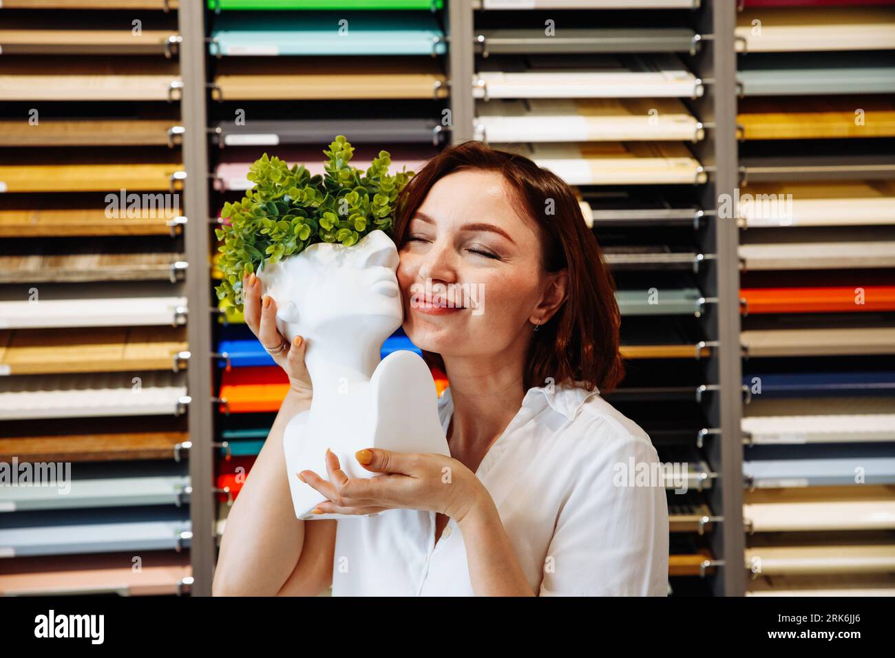young smiling female woman, white vase head with leaves in her hands on ...