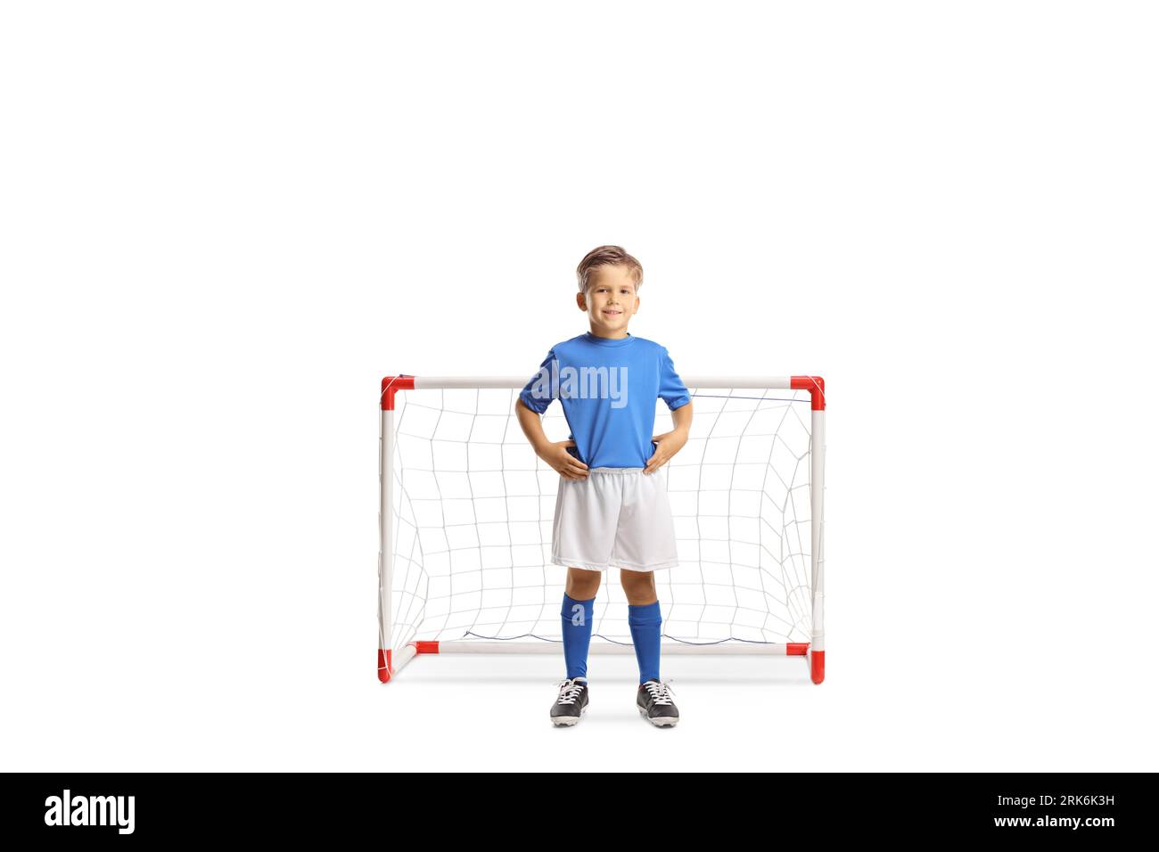 Full length portrait of a boy in a football kit posing in front of a ...