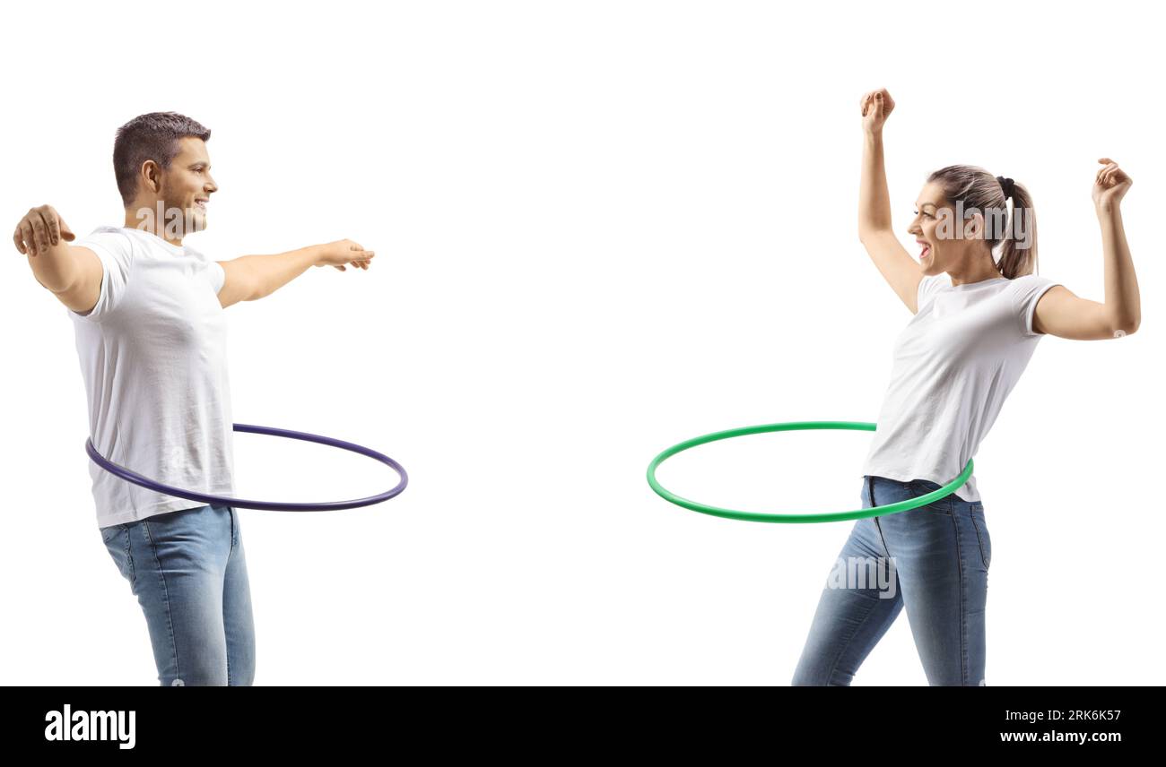 Profile shot of a man and woman spinning a hula hoops isolated on white ...