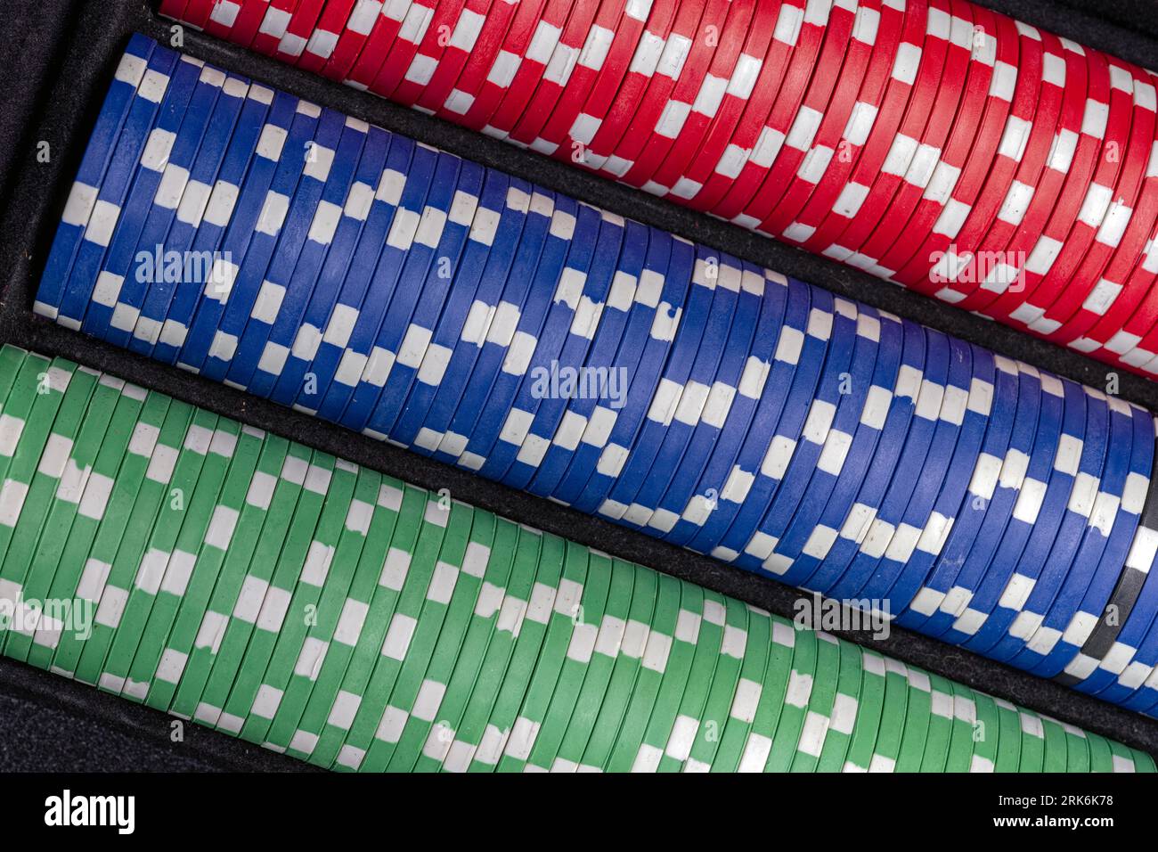 Edges of poker chips packed sideways in a box Stock Photo - Alamy