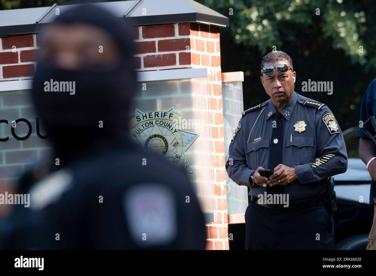 Fulton County Sheriff Patrick Labat surveys the scene in front of the ...