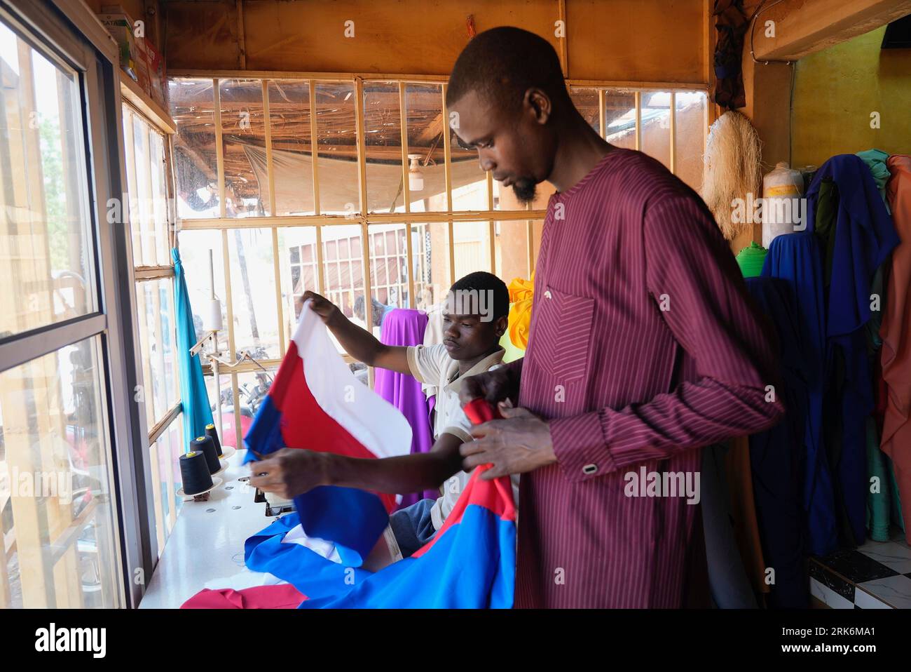Seamsters make Russian flags in Niamey, Niger, Thursday, Aug. 24, 2023 ...