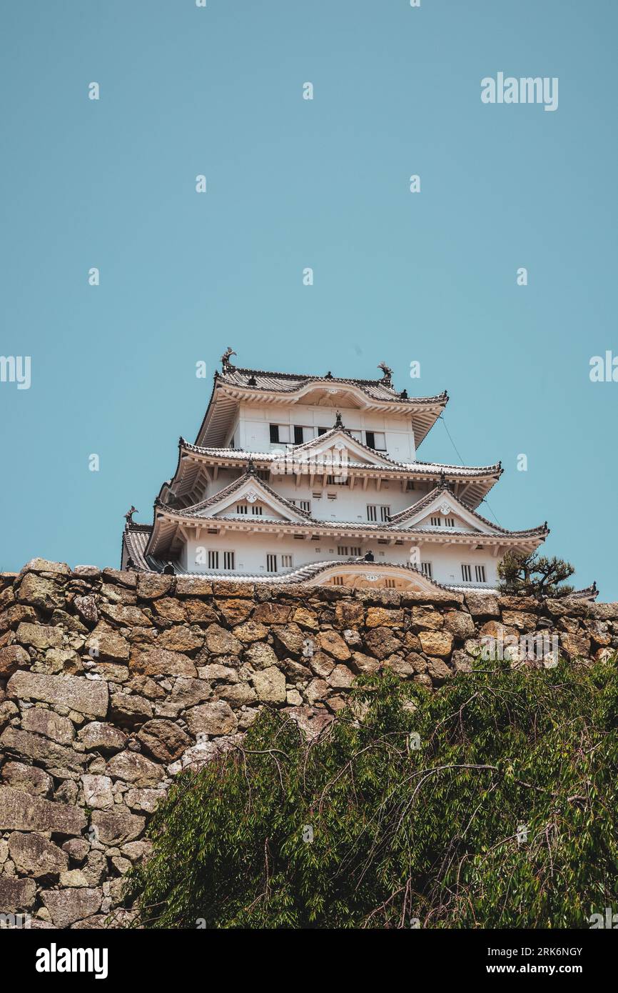 A vertical shot of the Himeji Castle in the daylight in Japan Stock ...