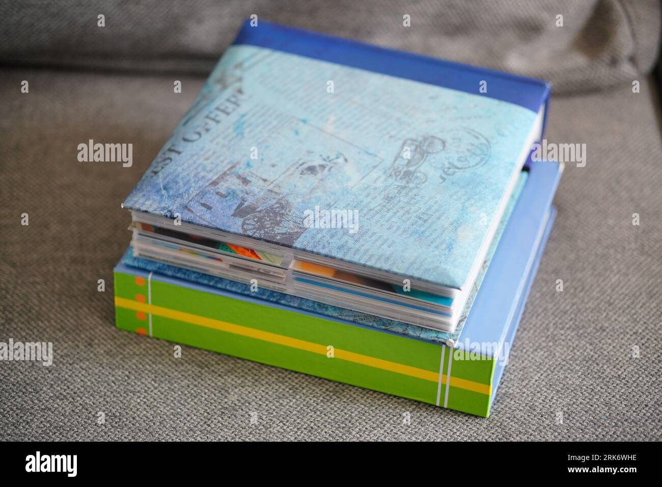 An organized collection of family photo albums arranged in a stack ...